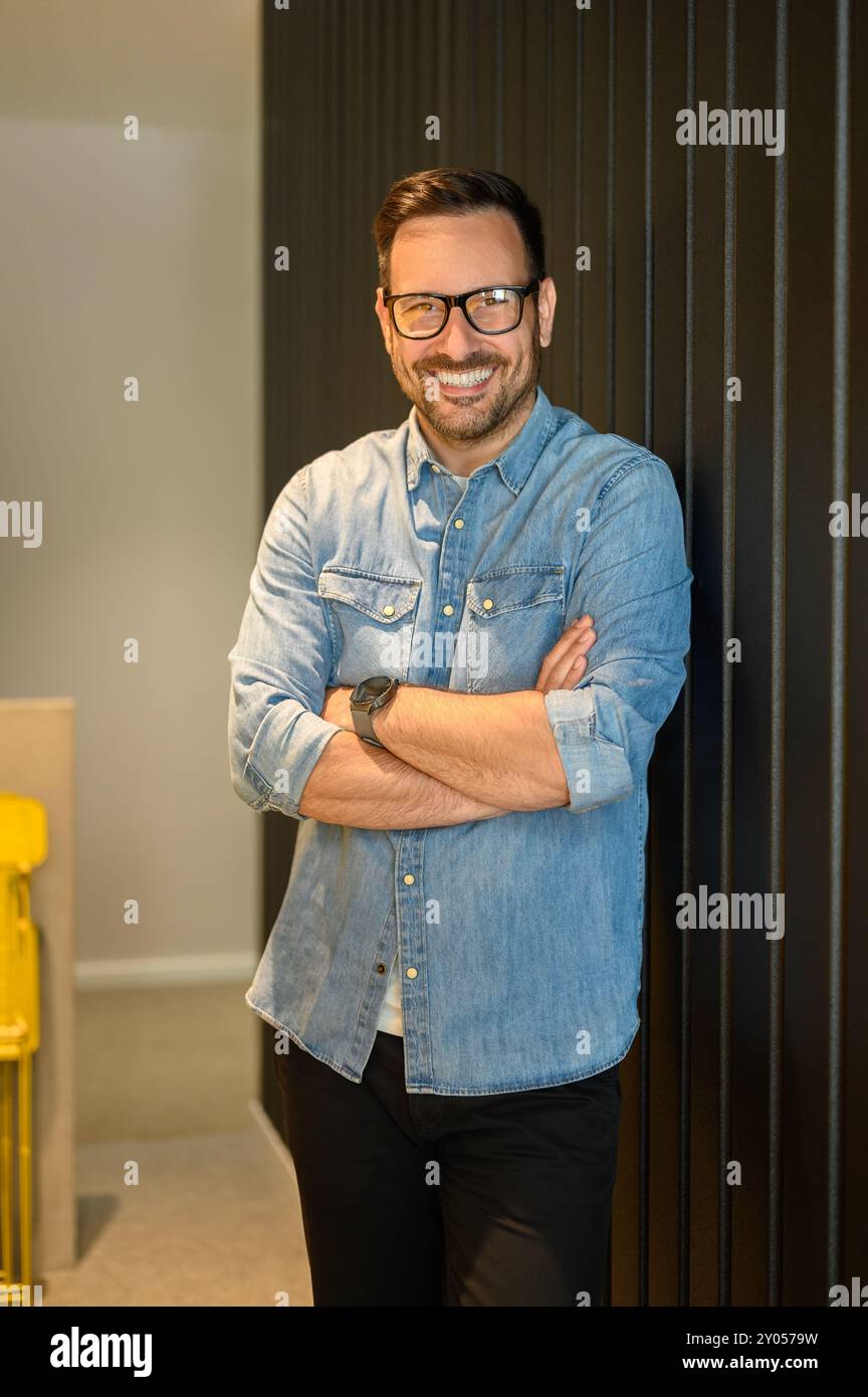 Portrait of handsome CEO with arms crossed smiling and standing ...