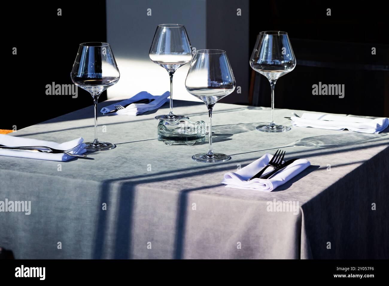 On the table, there are three elegant wine glasses along with various ...