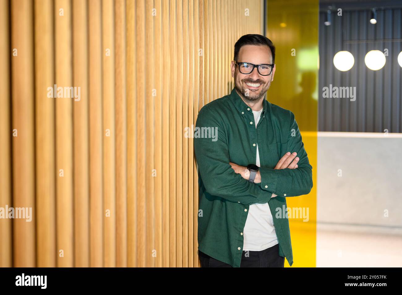 Portrait of positive bank manager with arms crossed and in glasses ...