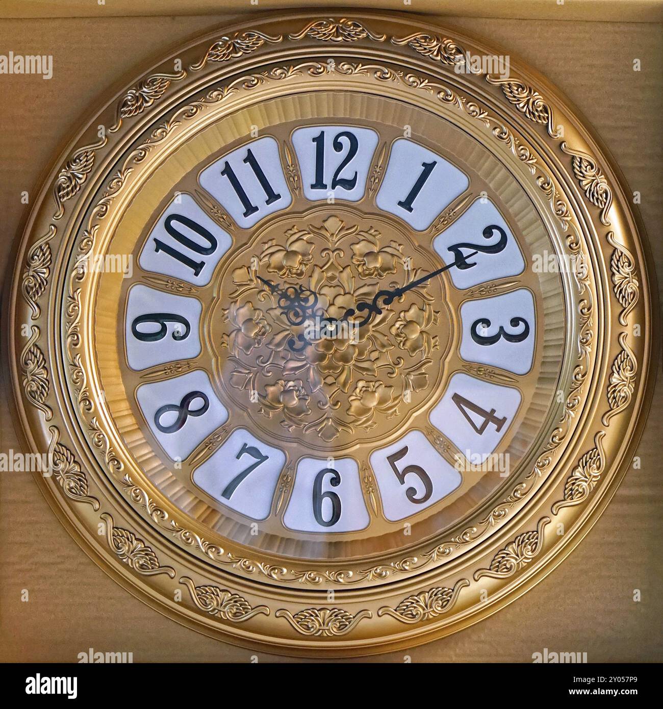 Big engraved plastic gold wall clock Stock Photo - Alamy