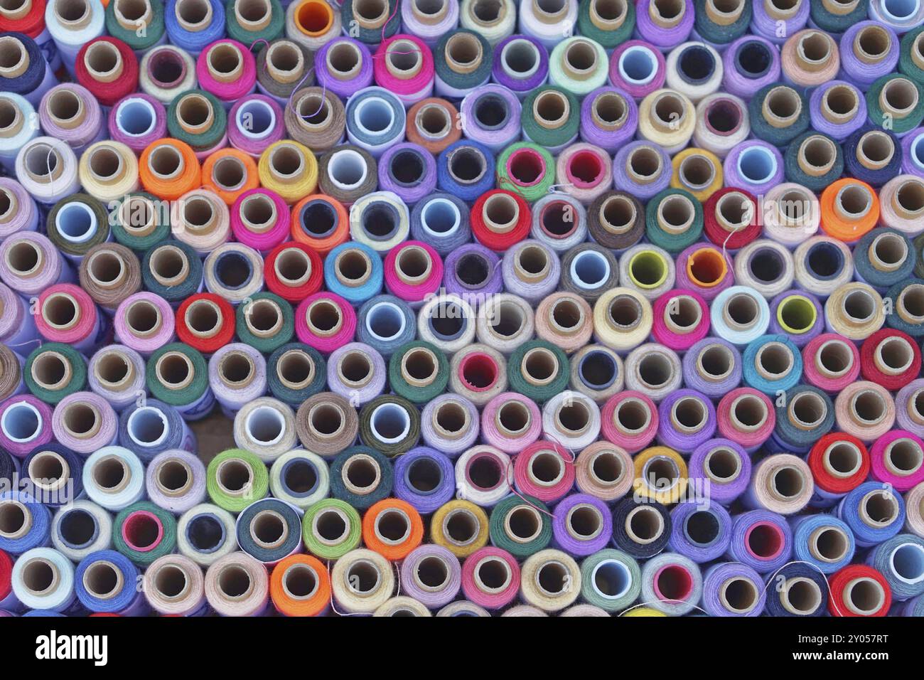 Colorful sewing yarns and threads background Stock Photo - Alamy