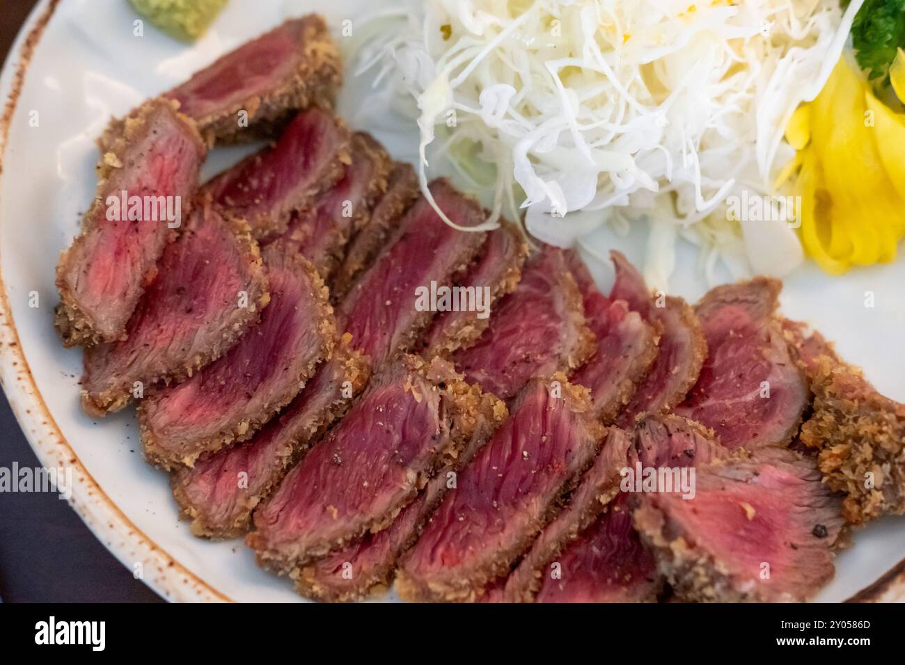 Set of Gyukatsu or beef cutlet served with cabbage. A traditional ...