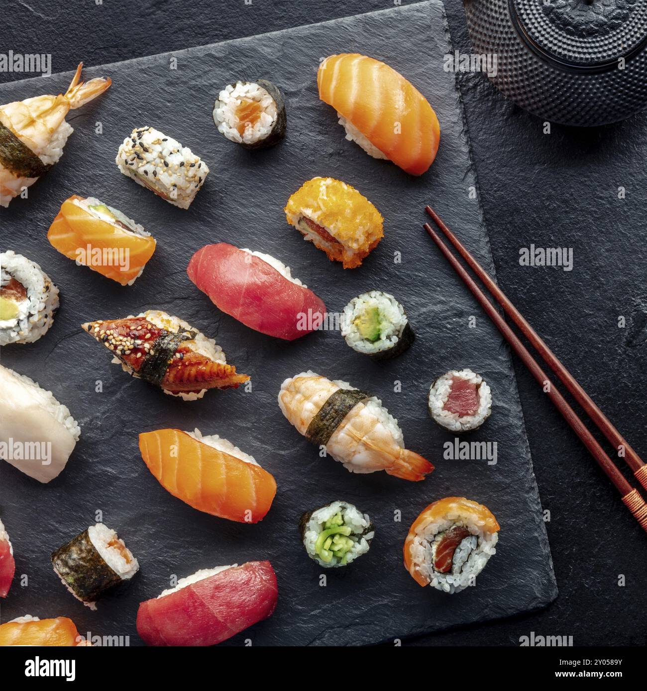 Sushi overhead square shot with chopsticks and tea. Rolls, maki, nigiri ...