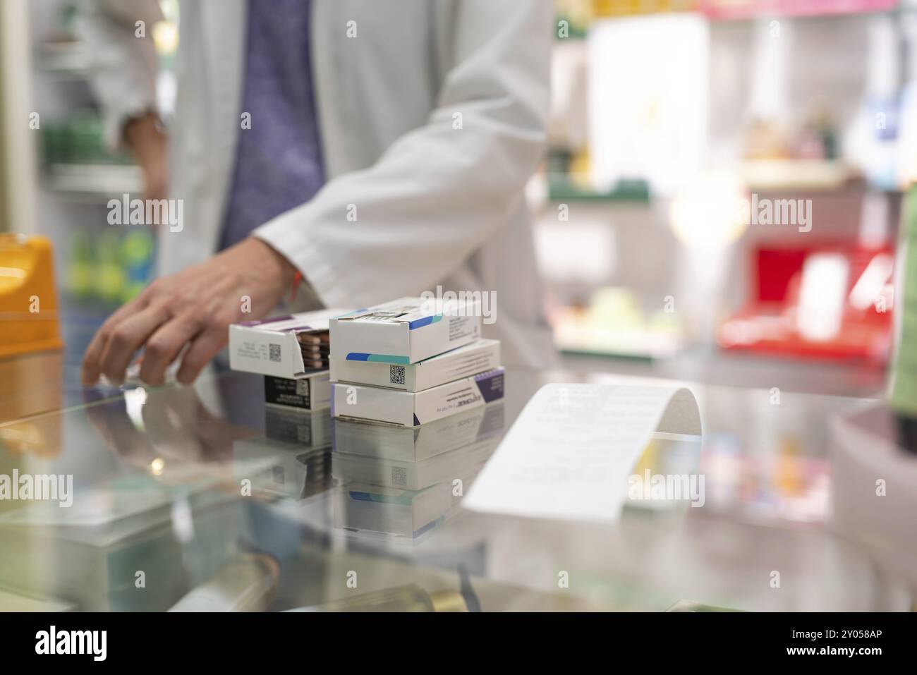 Medications stacked on a pharmacy counter, ready to be sold. Represents ...