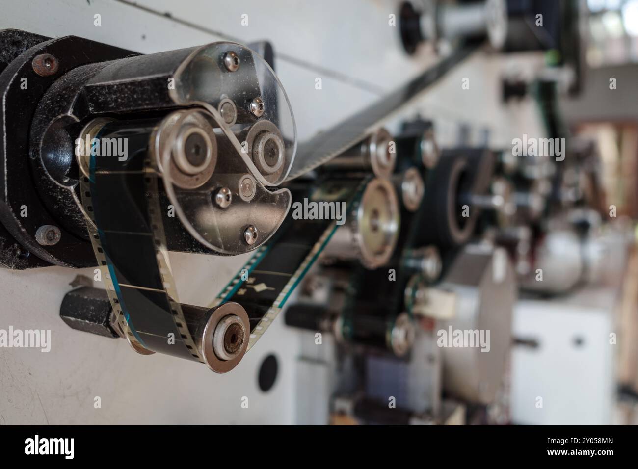 A detailed close-up view of a vintage film projector’s mechanical ...