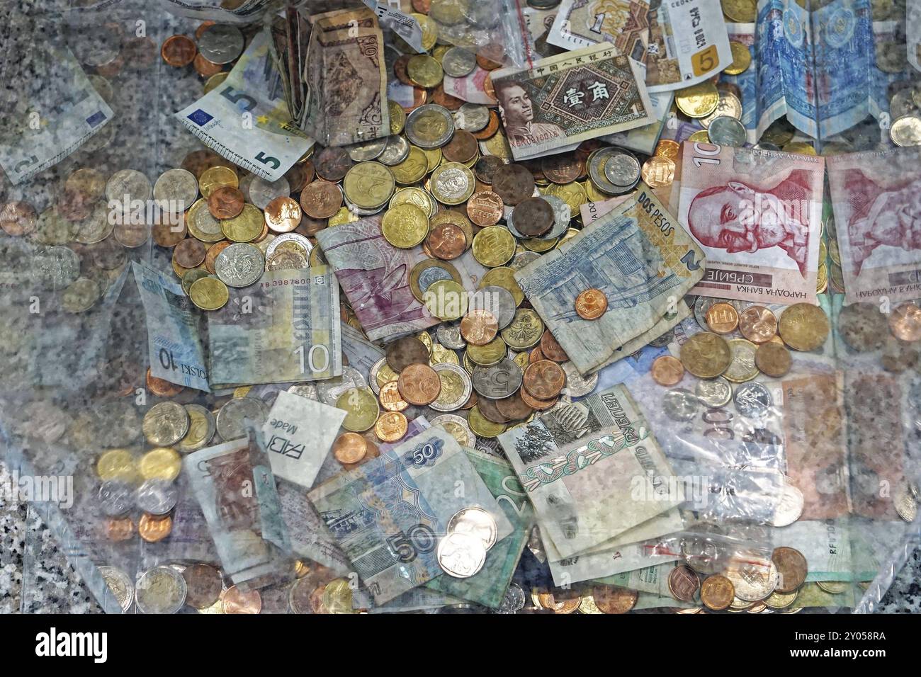 Mix coins and banknotes currency in clear donation money box Stock ...