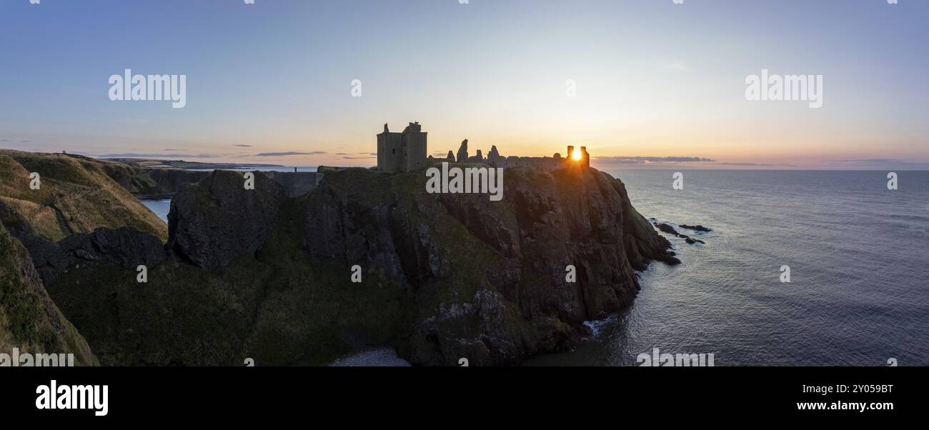 Dunnottar Castle, castle ruins at sunrise on the cliffs, drone shot ...
