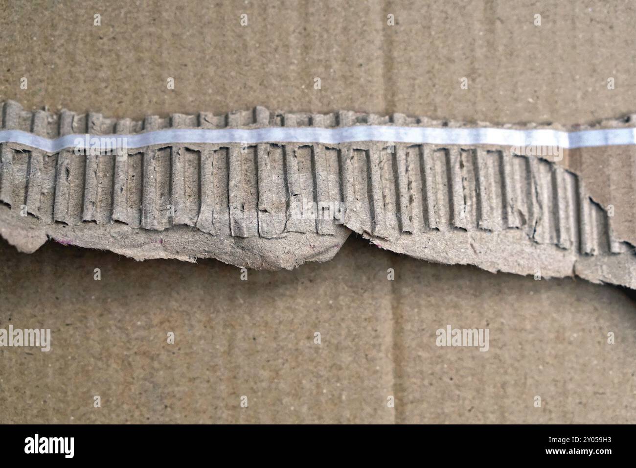 Pull to open strip at cardboard box Stock Photo - Alamy