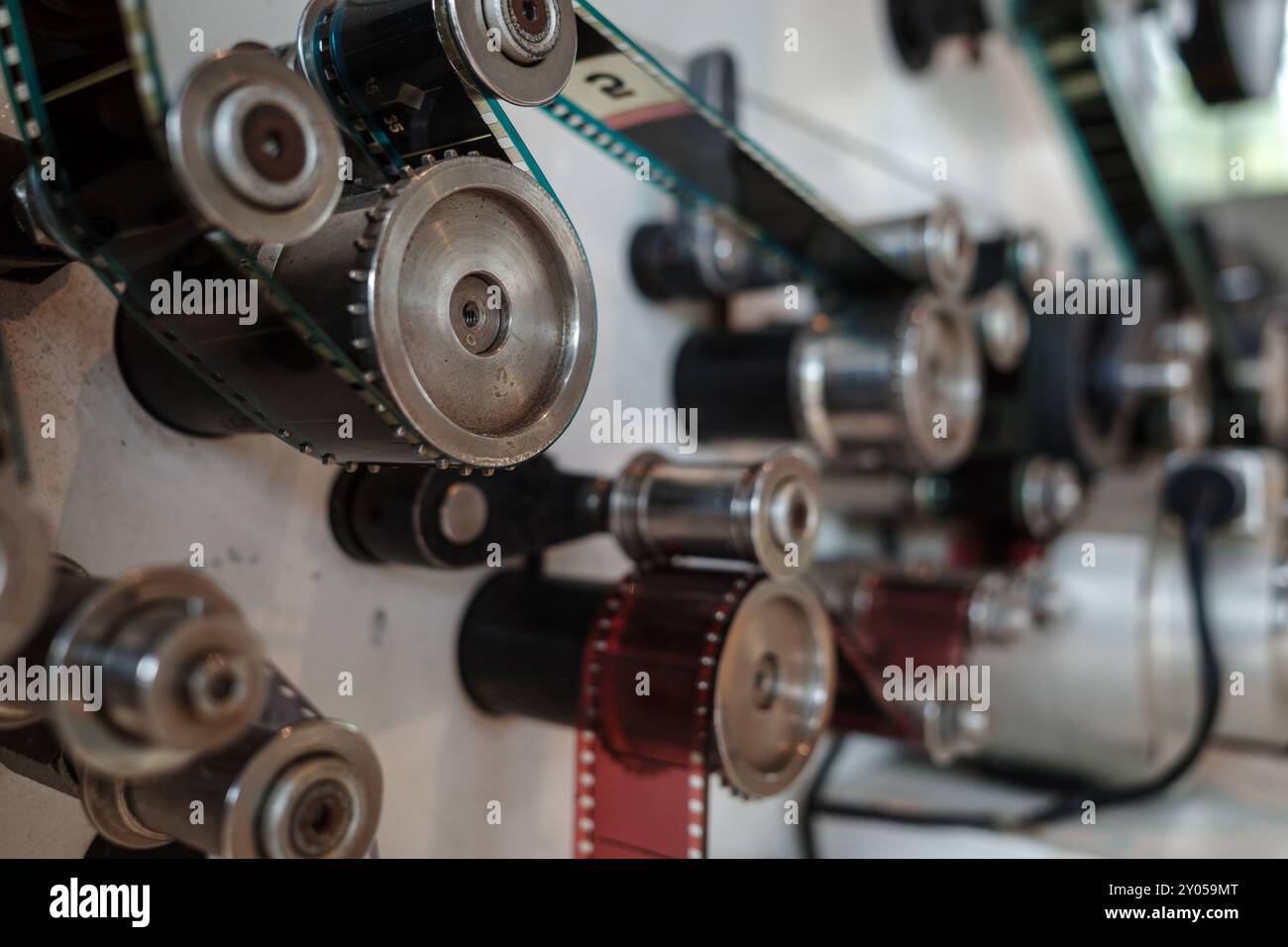A detailed close-up view of a vintage film projector’s mechanical ...
