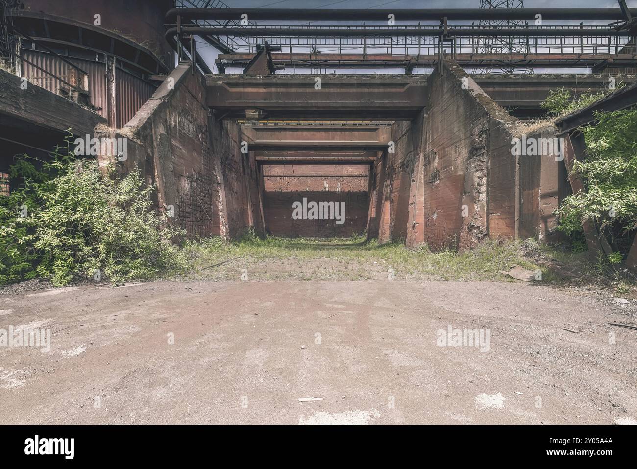 Abandoned industrial structure with concrete walls and traces of decay ...