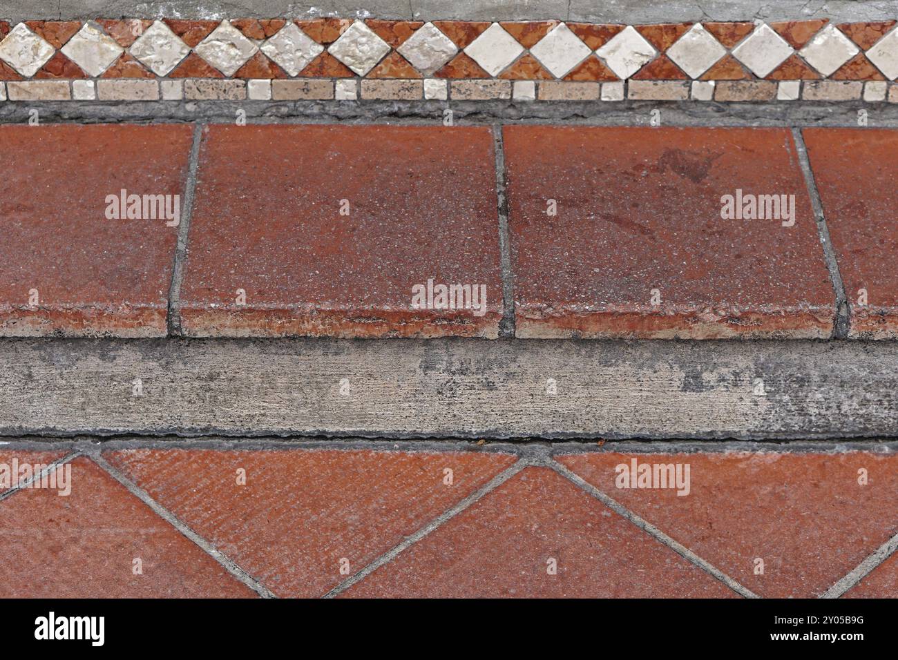 Red stone step with decorative tiles Stock Photo - Alamy
