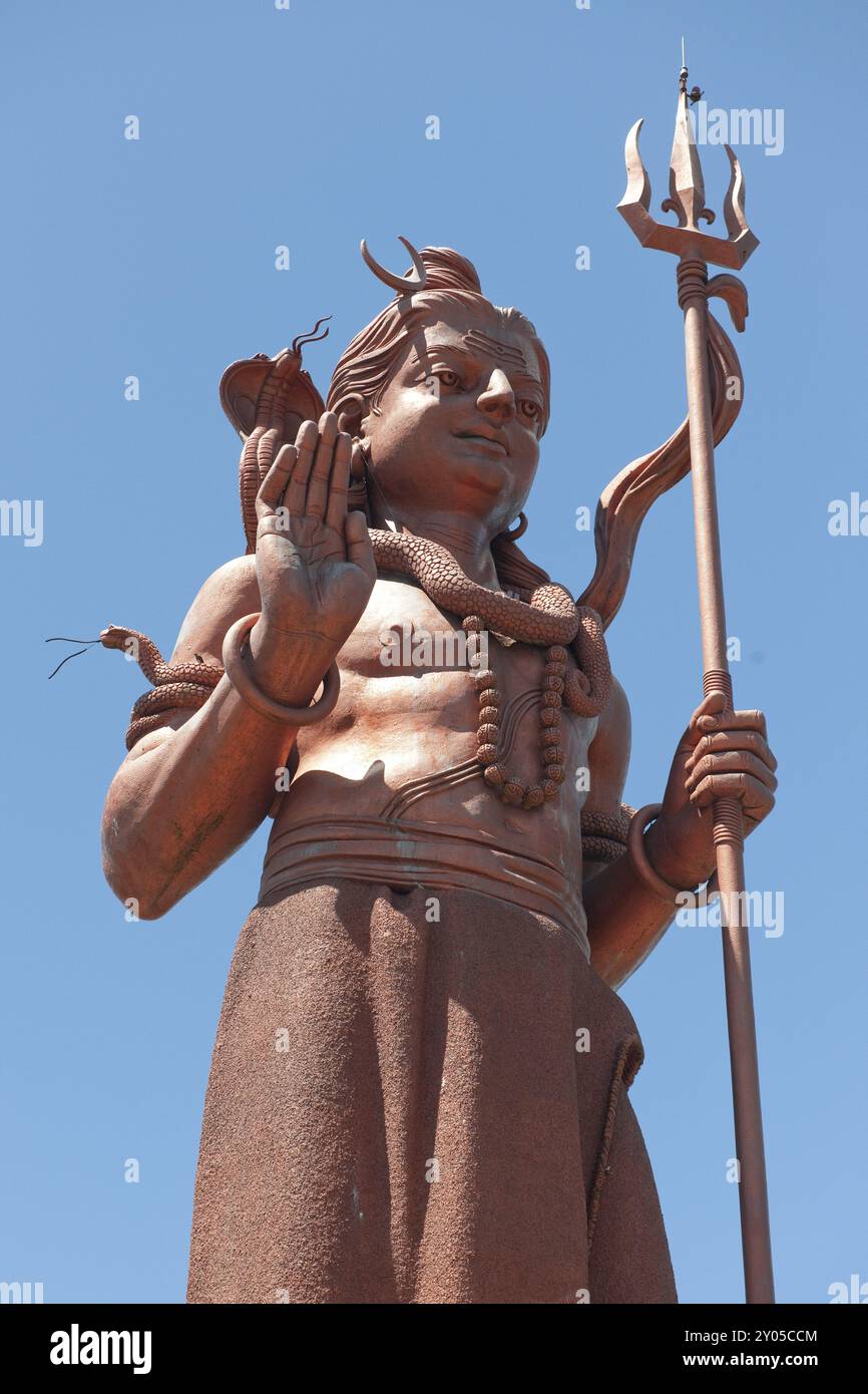 Photo from street level upward view of larger-than-life figure of god ...