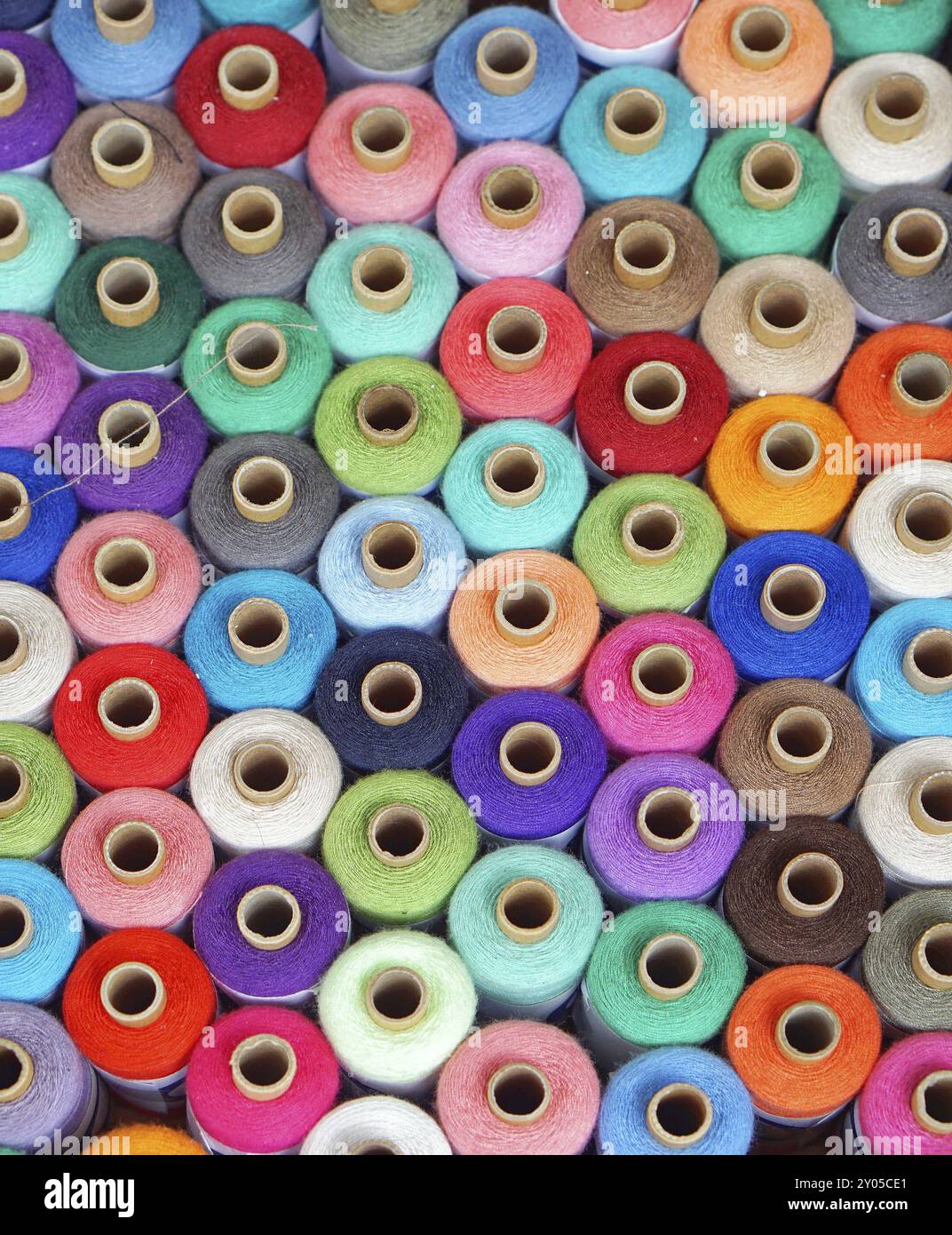 Colorful sewing threads and yarns at bobbins Stock Photo - Alamy