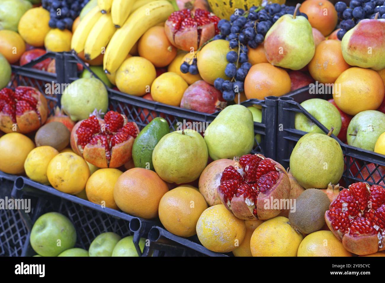 Fresh fruits in plastic baskets at market Stock Photo - Alamy
