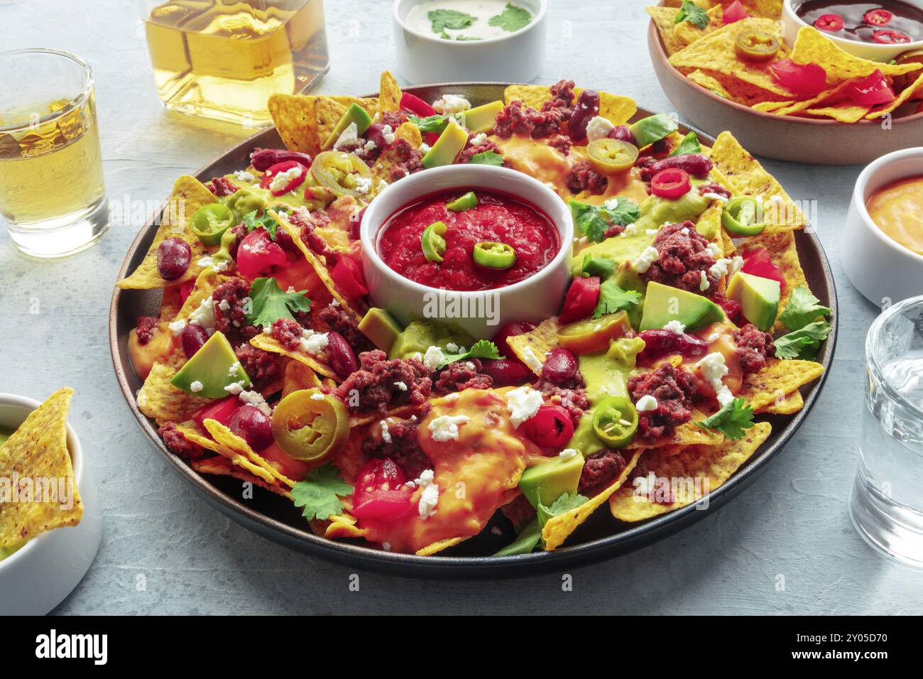 Loaded nachos. Mexican nacho chips with beef, with guacamole sauce ...