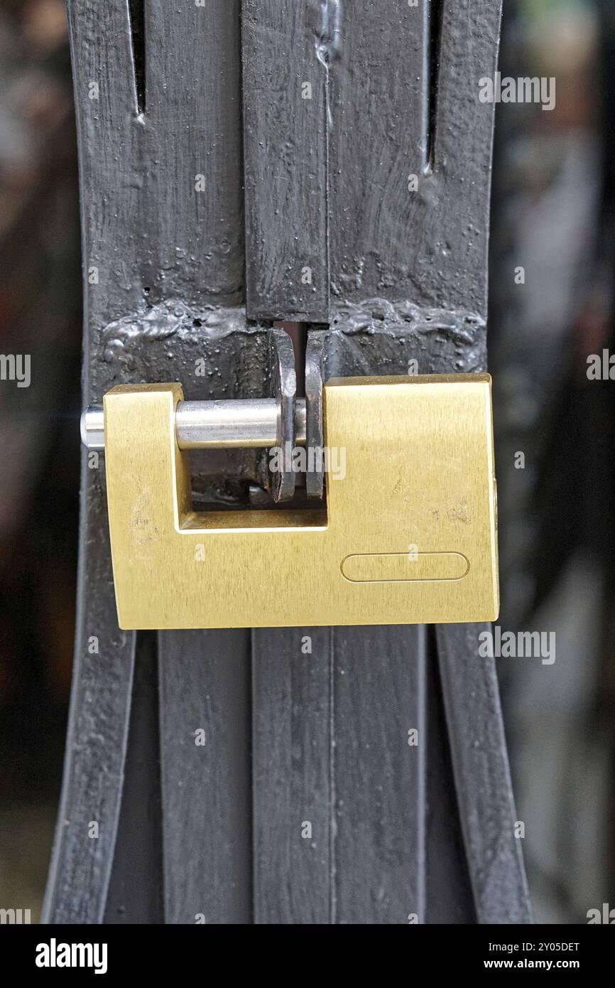 Strong padlock at locked gate security Stock Photo - Alamy