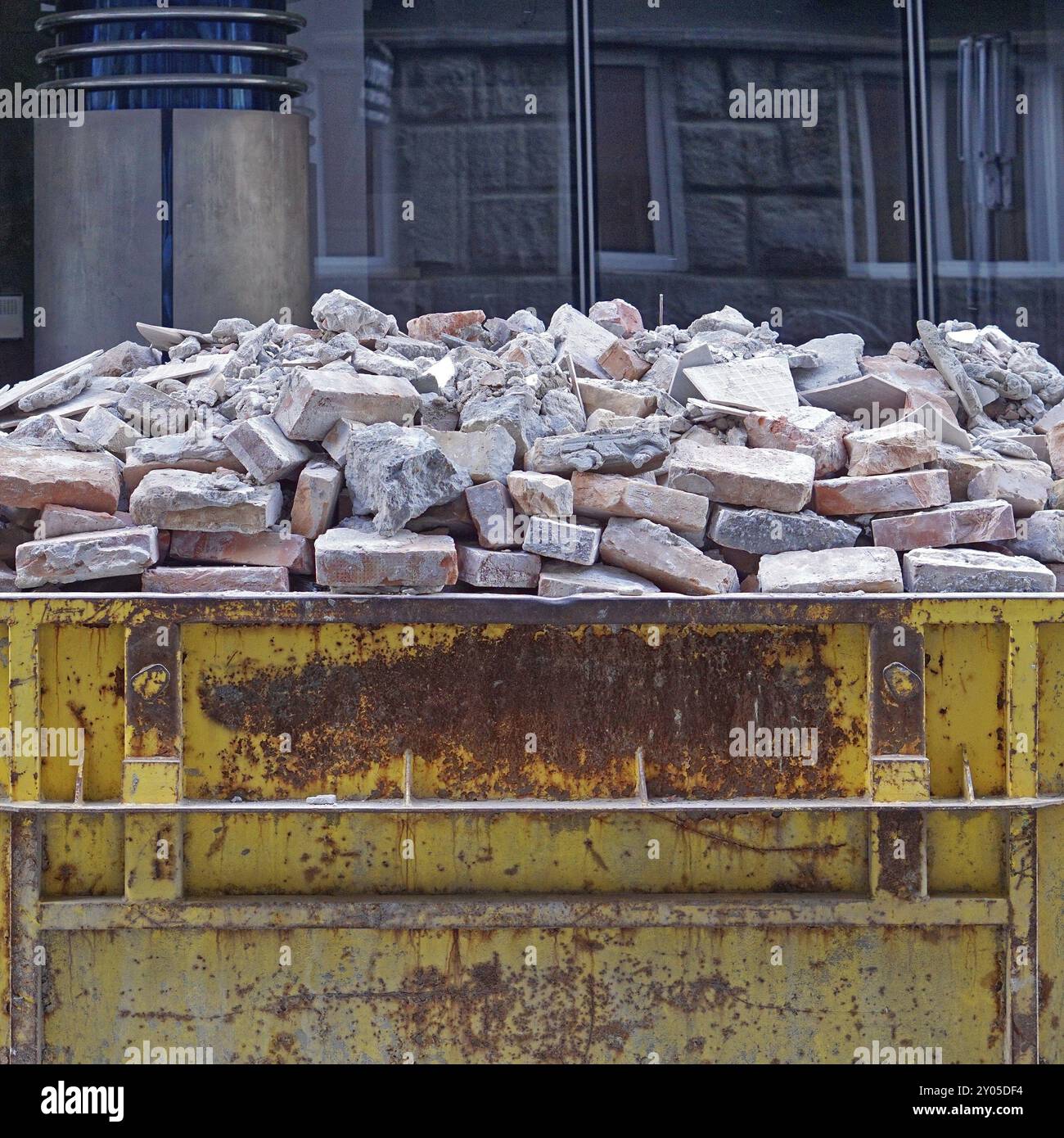 Over filled skip container with brick debris Stock Photo - Alamy