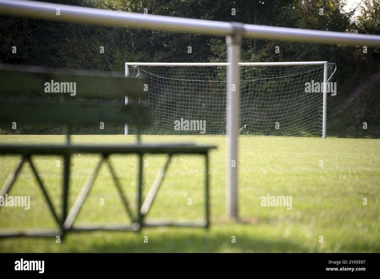 Bench at the edge of a football pitch Stock Photo - Alamy
