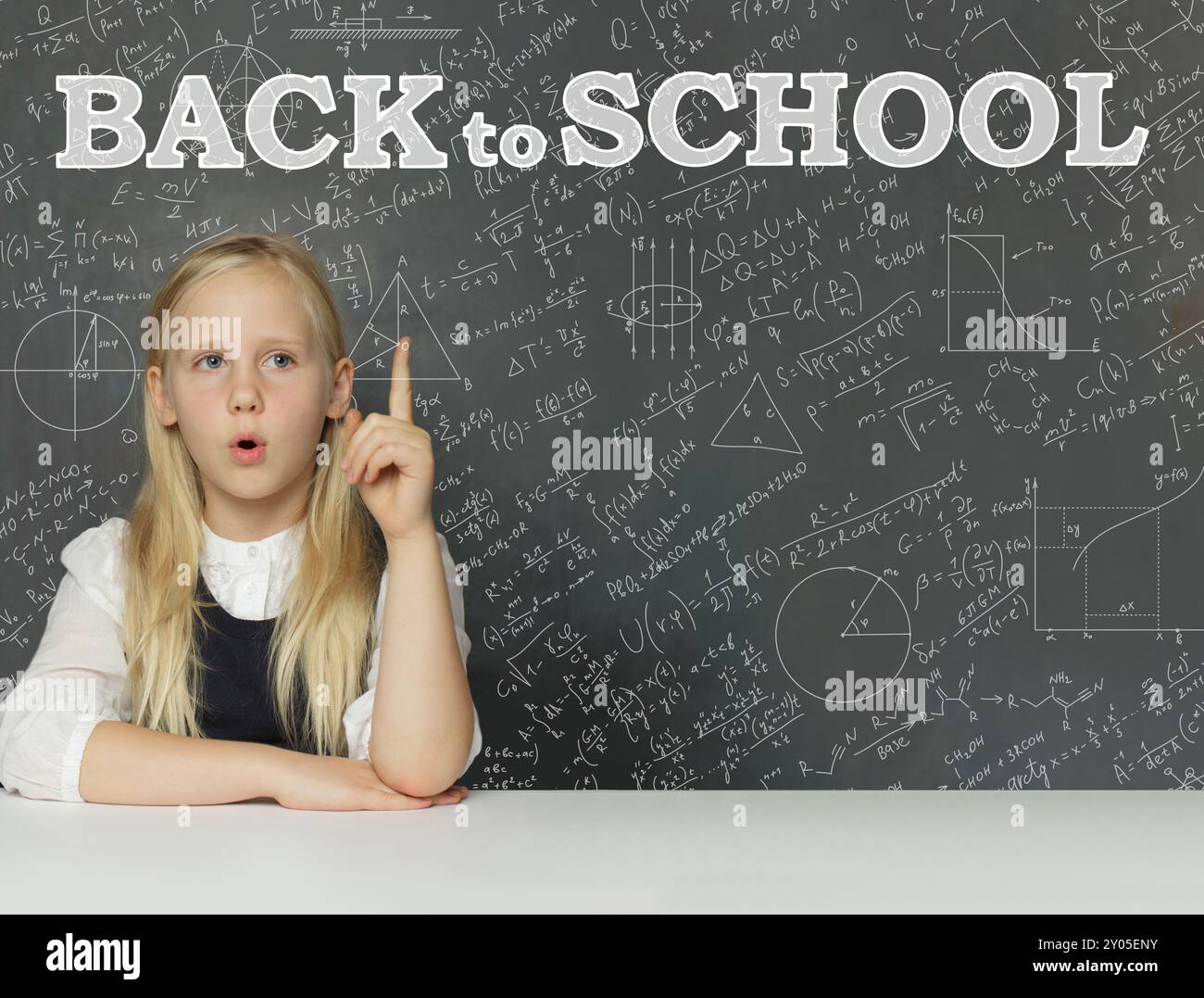 Young school girl child student pointing finger at Back to school ...