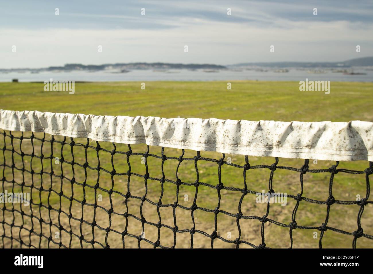 Beach Volleyball Net In autumn with grass and aged net with defocused ...