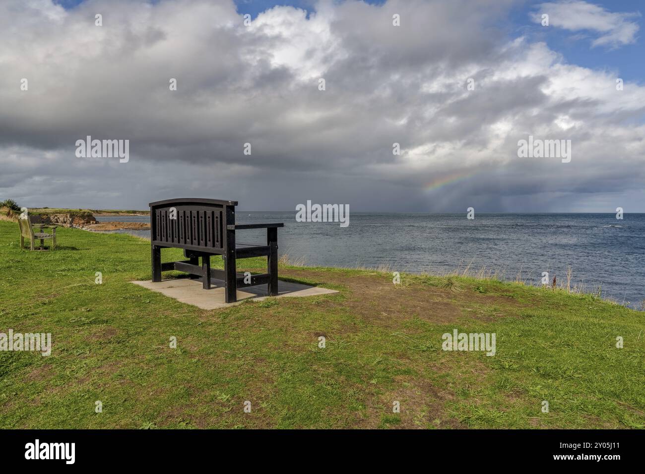 A bench with a Rainbow over the North Sea coast, seen in Benthall ...