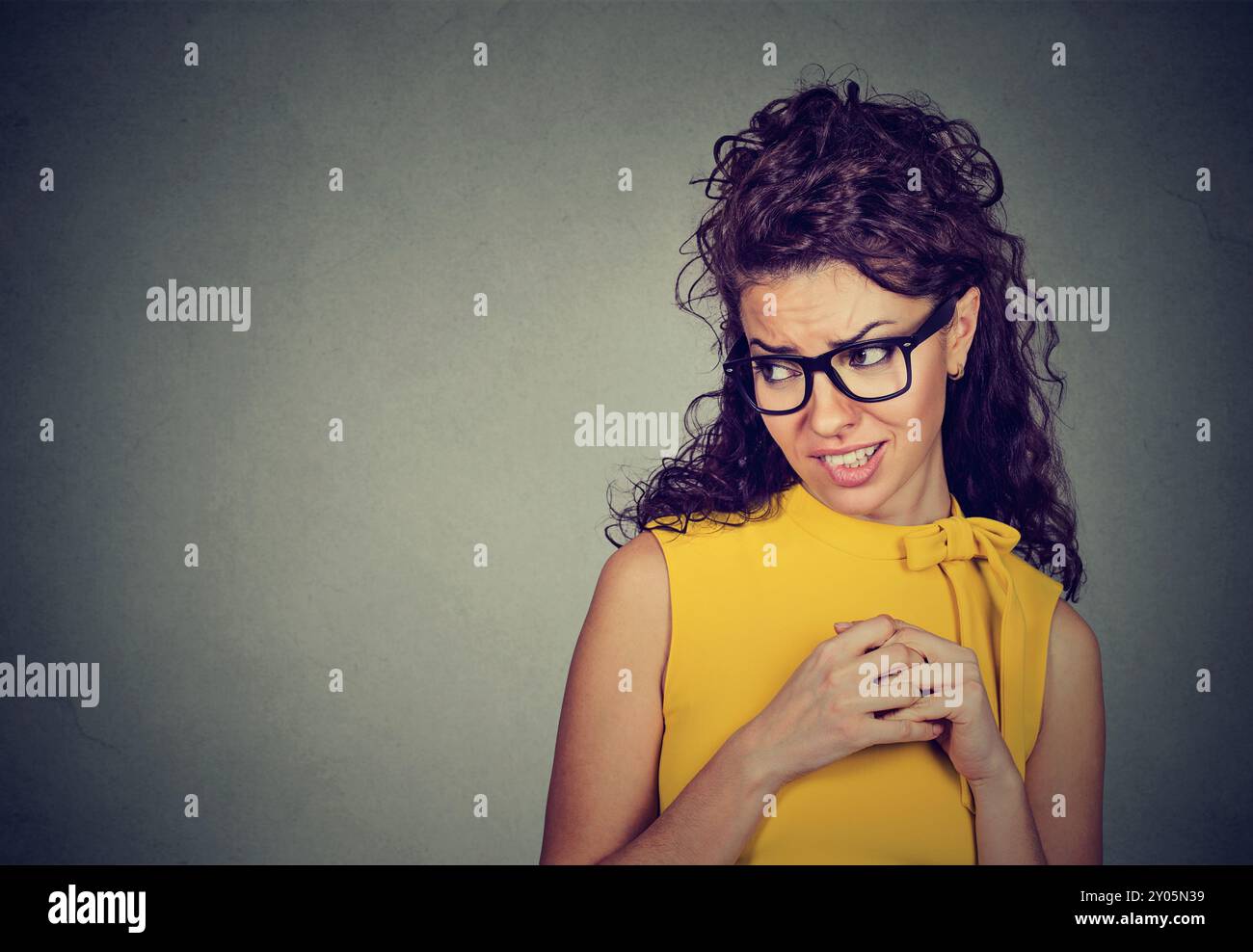 Portrait of a shy insecure young woman avoiding eye contact Stock Photo ...