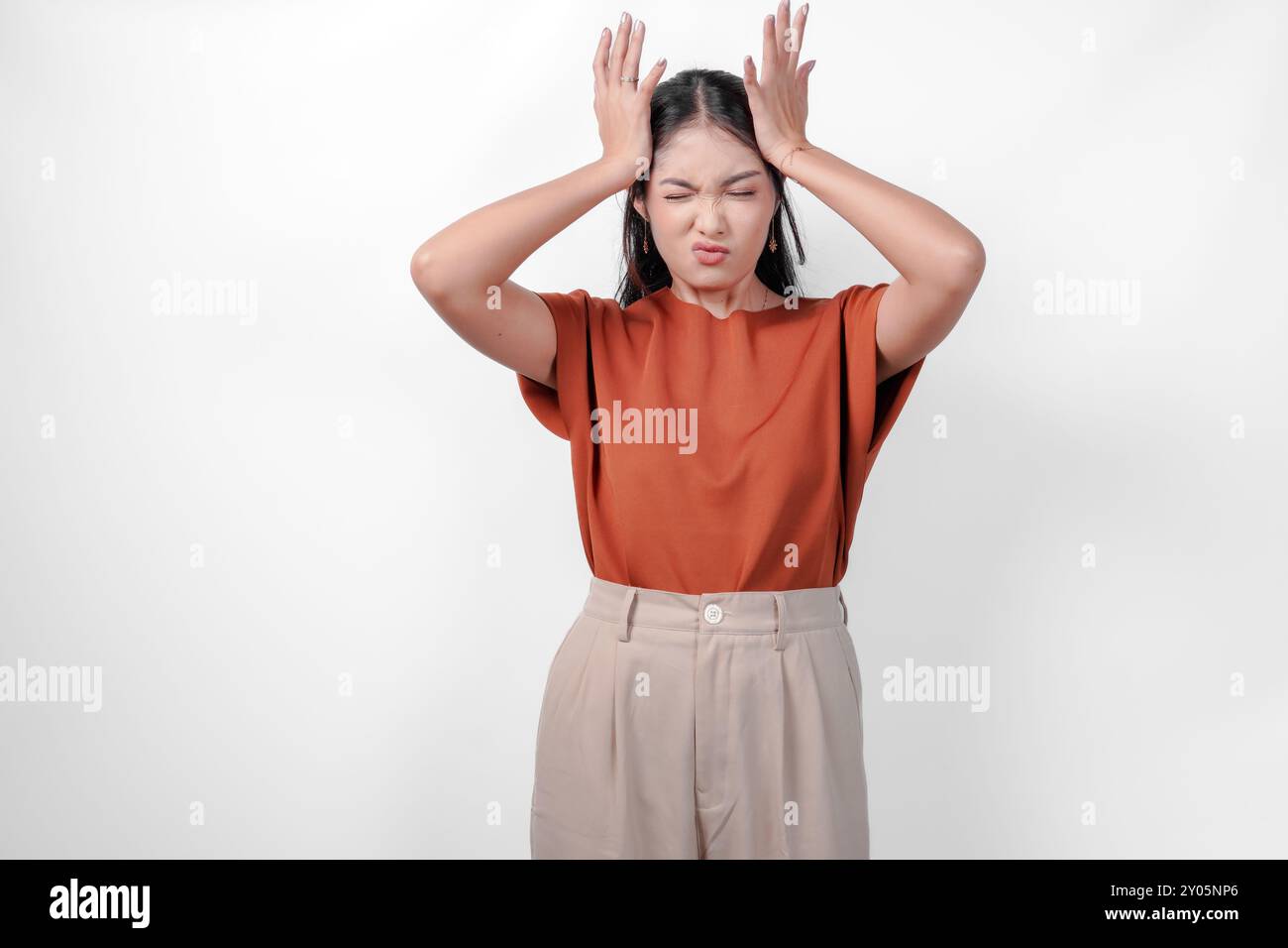 Stressed Asian woman suffering from severe headache, pressing hands to ...