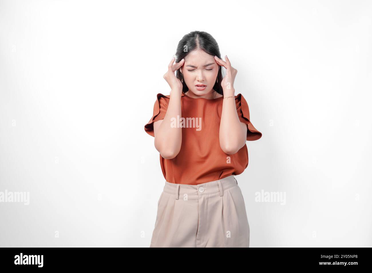 Stressed Asian woman suffering from severe headache, pressing hands to ...