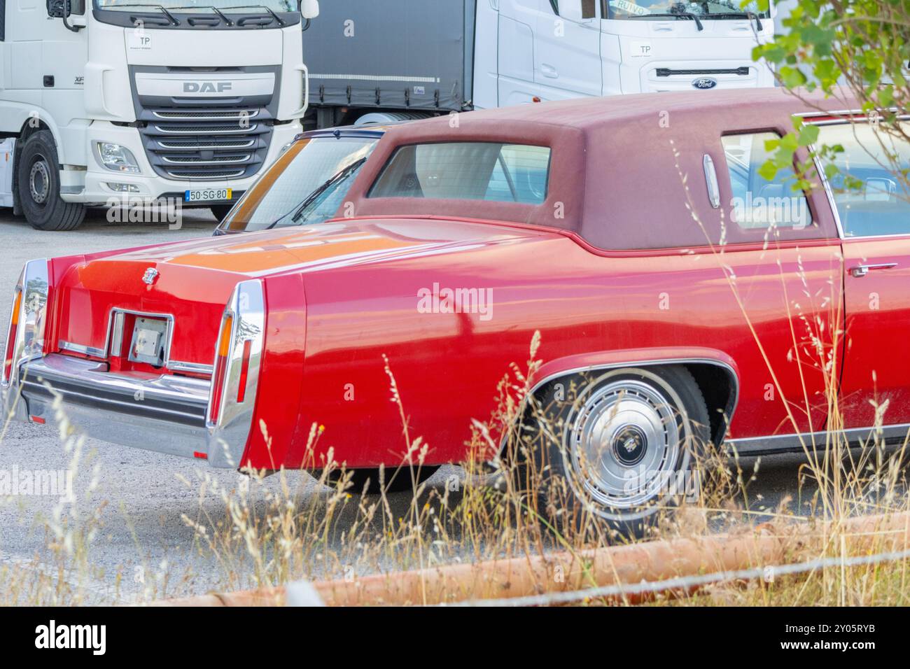 Red cadillac fleetwood with a brown vinyl roof parked in a parking lot ...