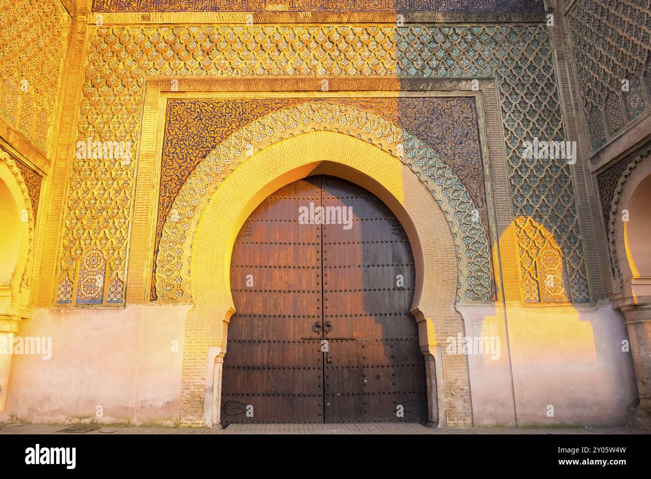 Golden hour at centered Bab al mansour gate in the old town medina of ...