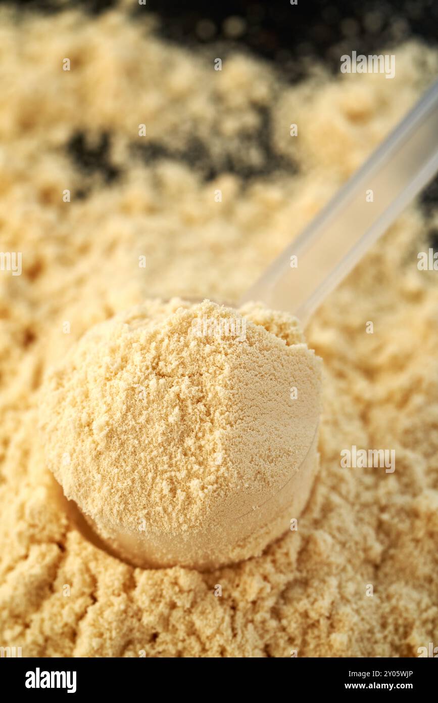 Whey protein powder in a measuring cup Stock Photo - Alamy