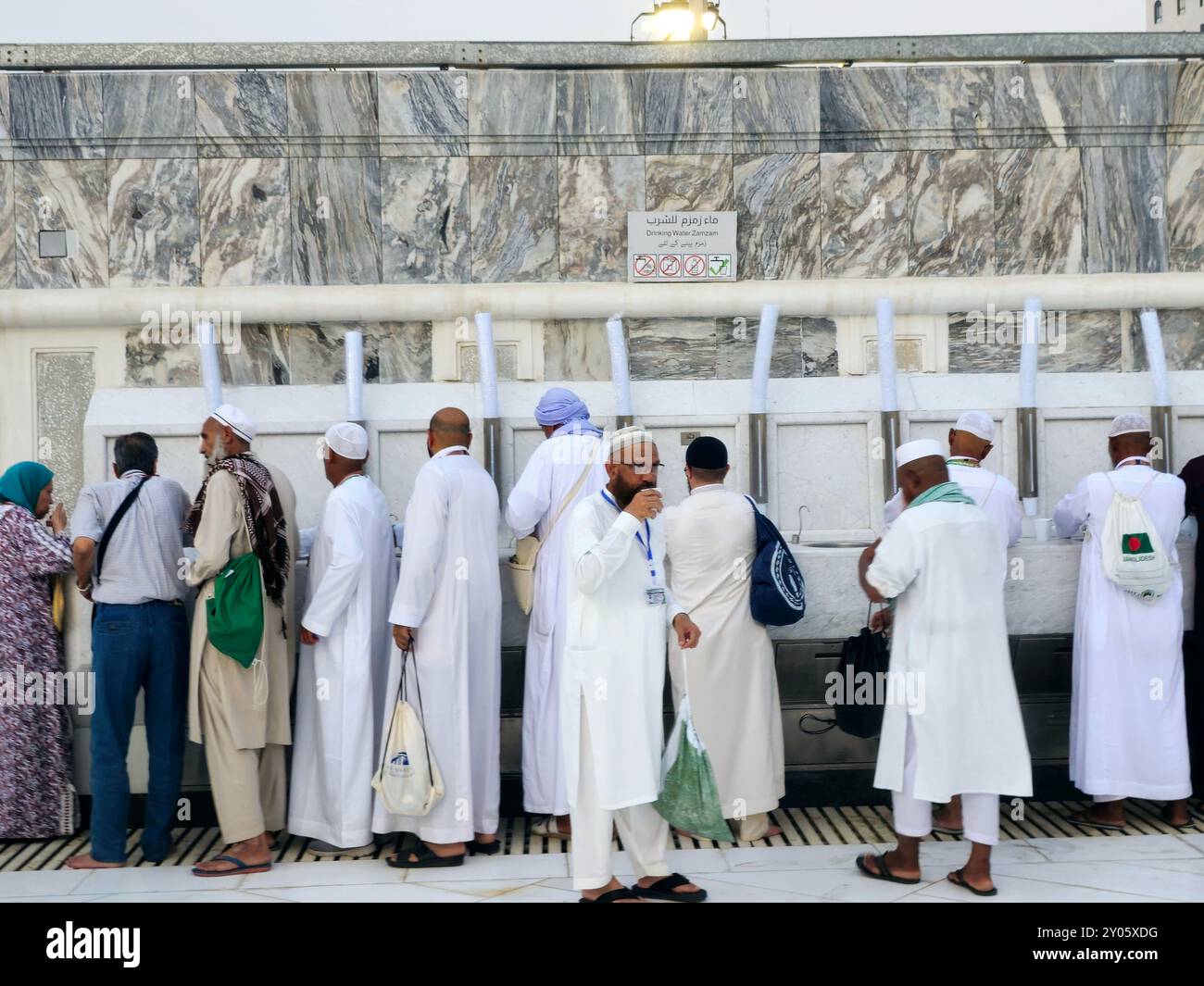 Mecca, Saudi Arabia, June 4 2024: pilgrims drinking from Zamzam well ...