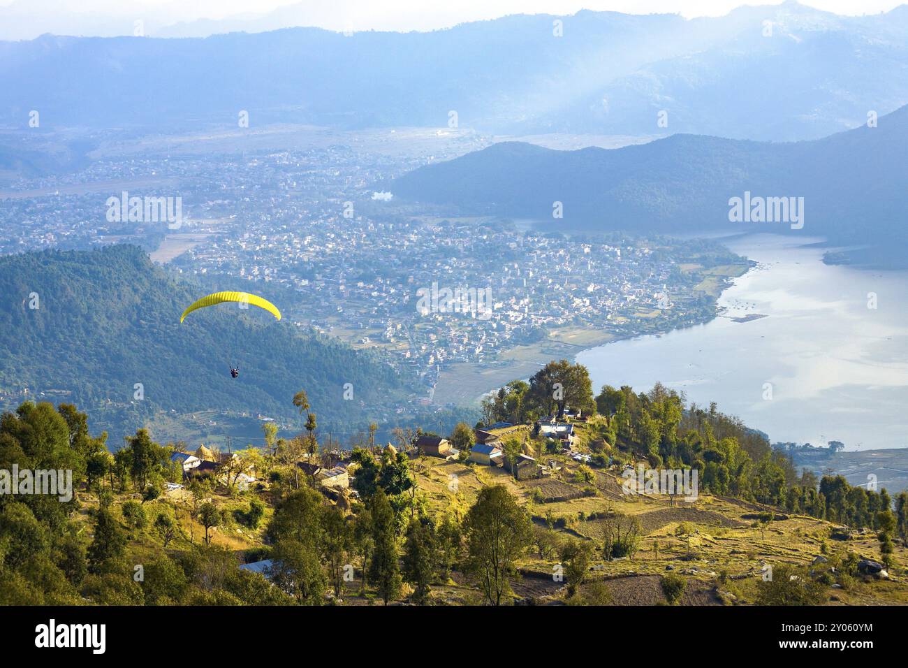 High angle aerial view of paraglider descending onto Pokhara and Phewa ...
