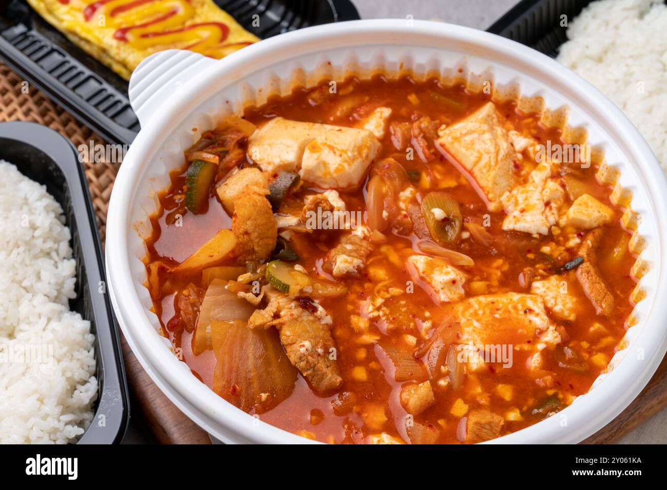 Korean food, kimchi stew, ham, soft tofu, pork, egg roll, rice, side ...