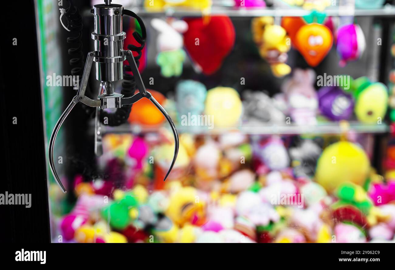 Mechanical claw game machine. Close-up view Stock Photo - Alamy