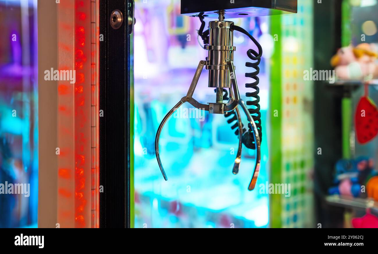 Mechanical claw game machine. Close-up view Stock Photo - Alamy
