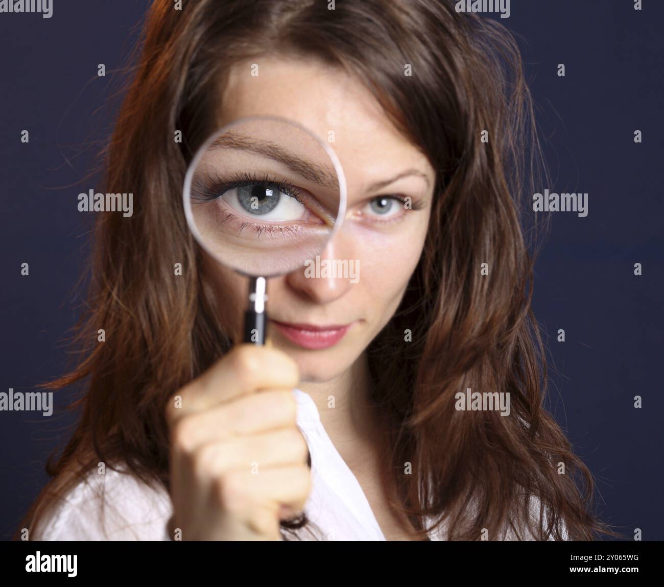 Cute woman with magnifying glass Stock Photo - Alamy