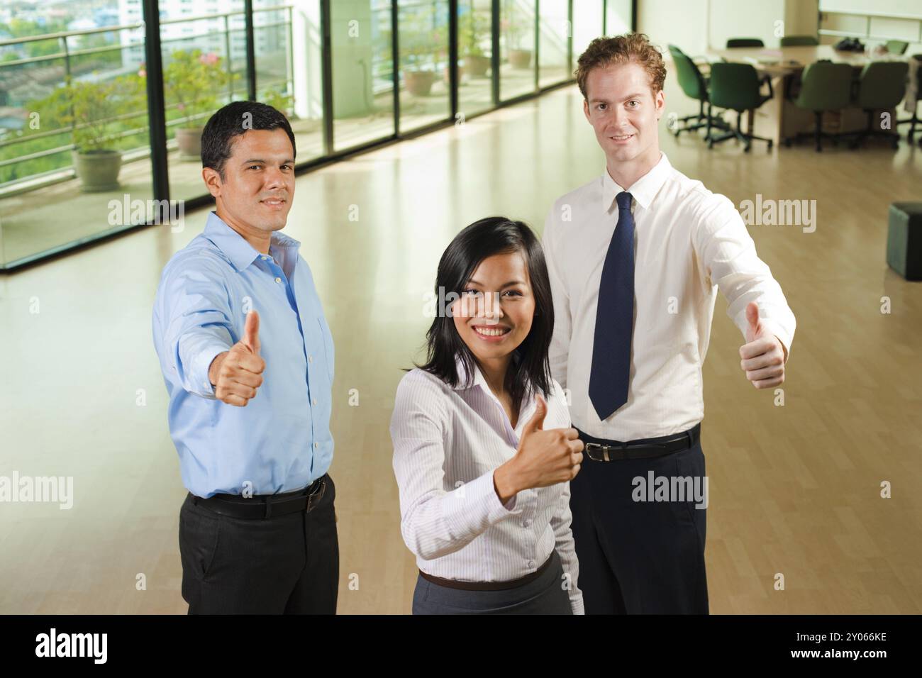 A happy group of three diverse business people each display a cheerful ...