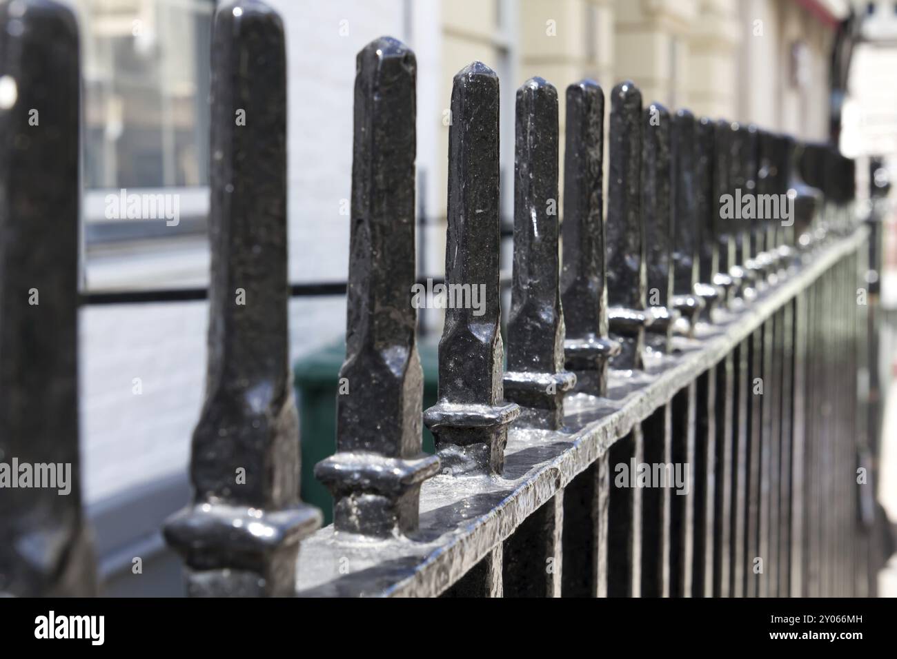 Wrought iron fence with spikes Stock Photo - Alamy