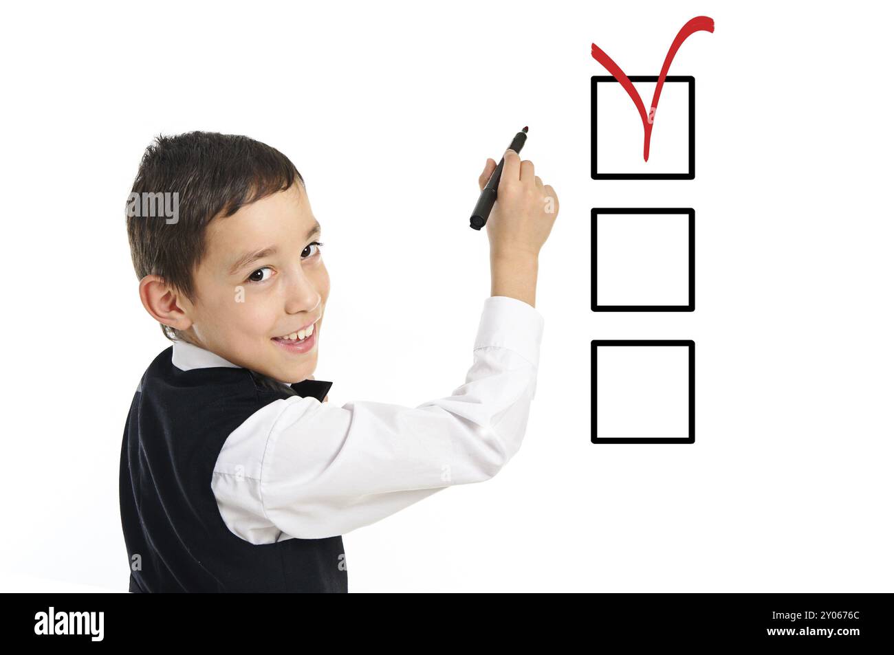 Portrait of a young school boy wrighting or drawing checkboxes with ...