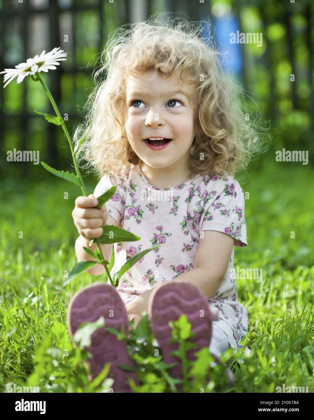 Happy smiling child playing outdoors in spring garden Stock Photo - Alamy