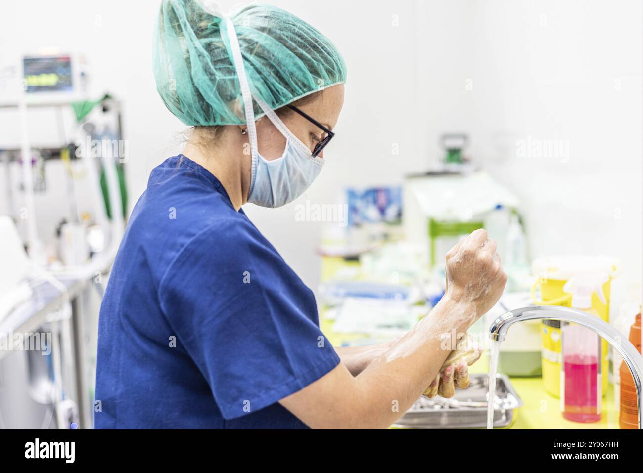 Coronavirus prevention. Nurse washing her hands after treat a patient ...