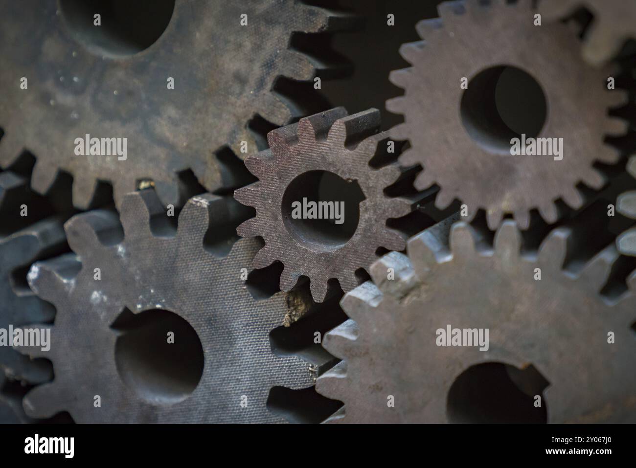 Interlocking gear wheels in front of a black wall Stock Photo - Alamy