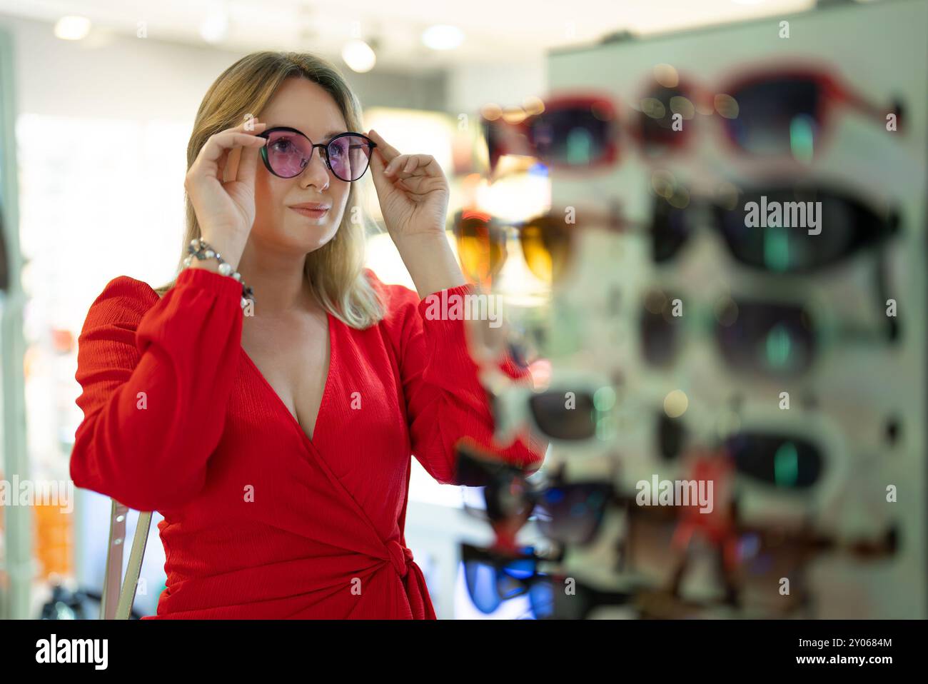 Woman tries choose eyeglasses hi-res stock photography and images - Alamy