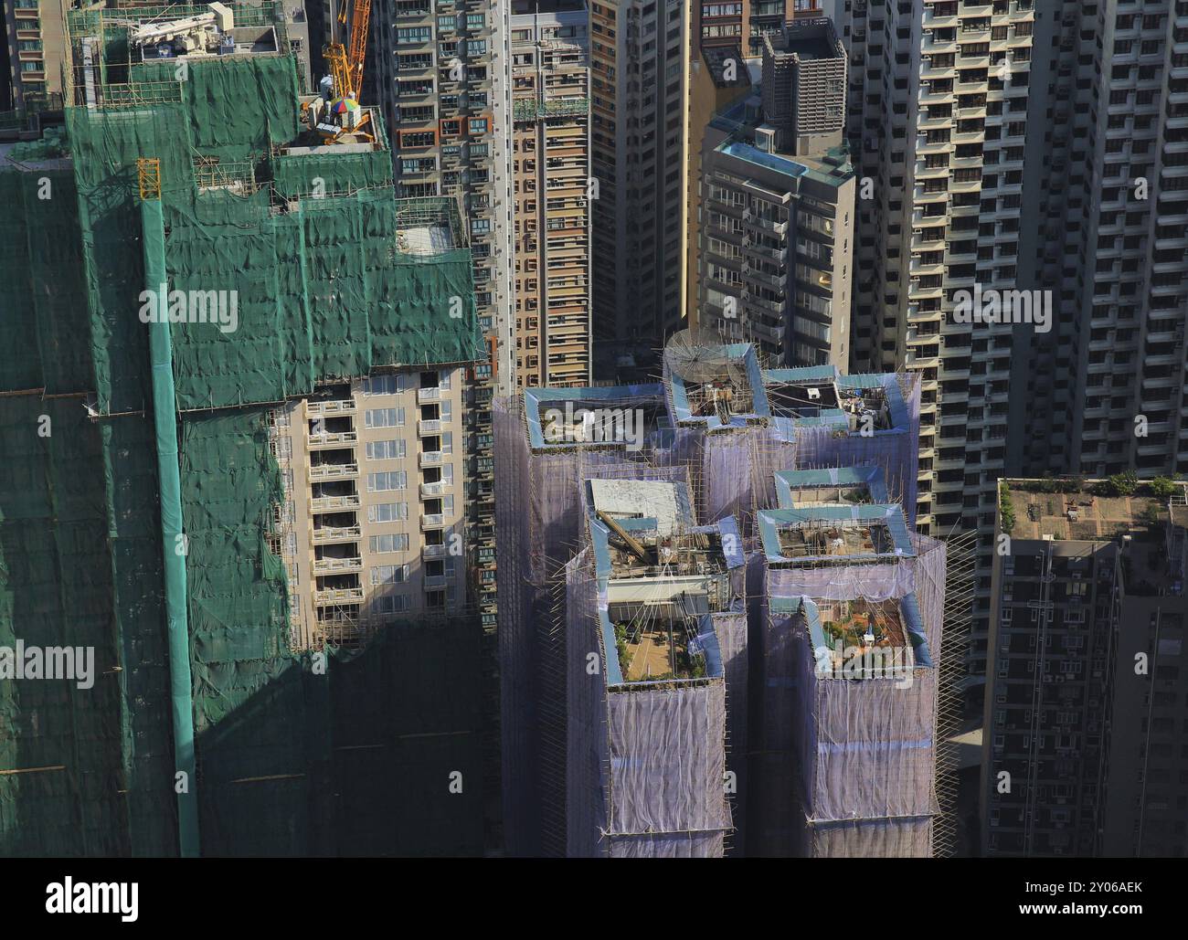 Construction site with scaffolds made of bamboo. Rooftop gardens. Scene ...