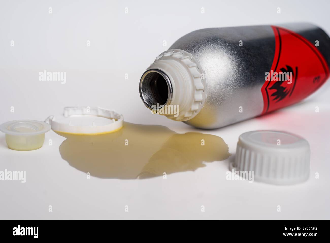 Aluminum bottle for sampling with a label for flammable liquids lying ...