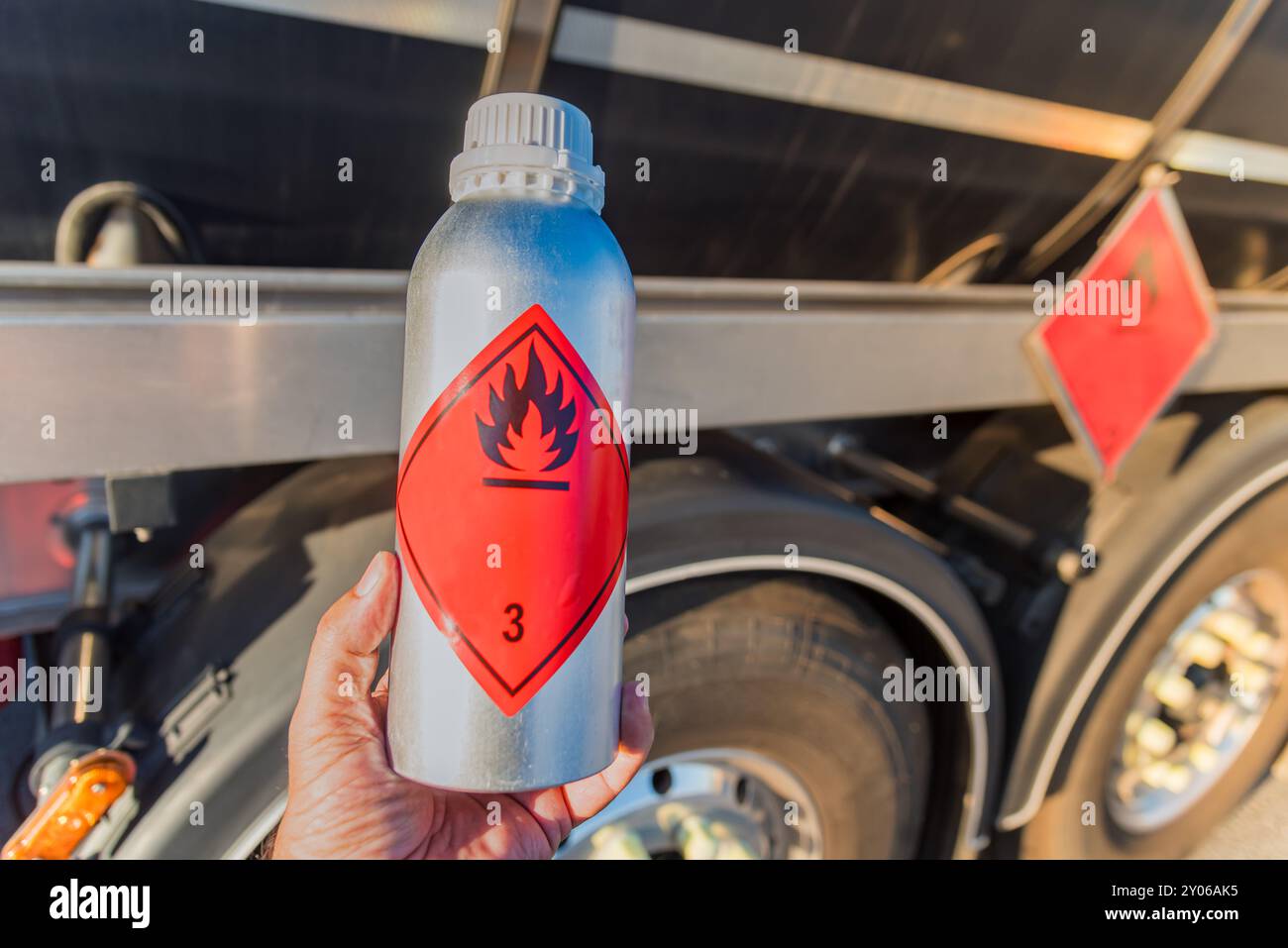 Aluminum bottle for sampling with a label for flammable liquids next to ...