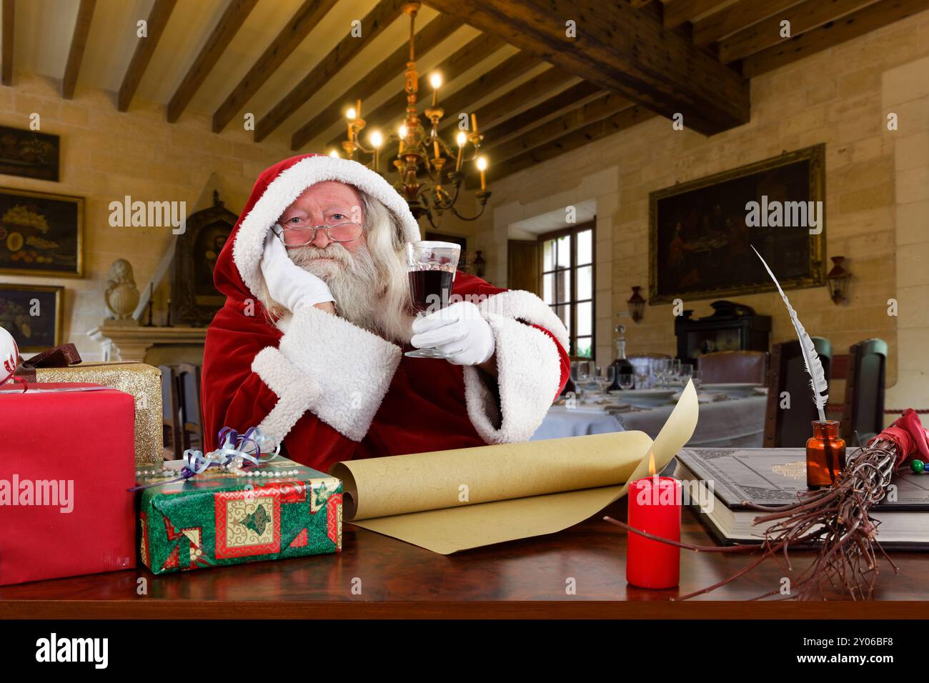 Father Christmas with a glass of red wine in his hand Stock Photo - Alamy