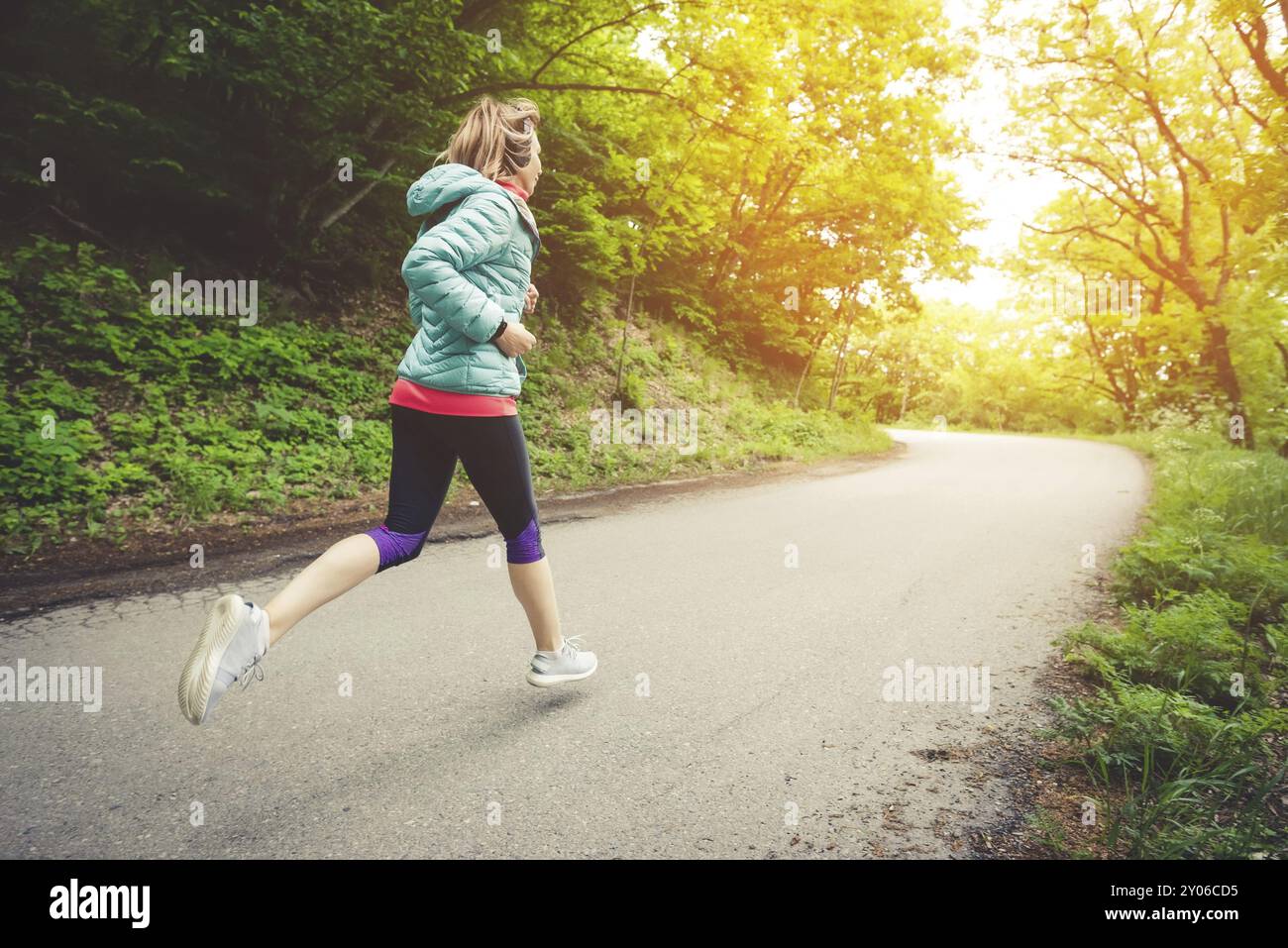 Young fitness blonde woman in headphones running at morning caucasian ...