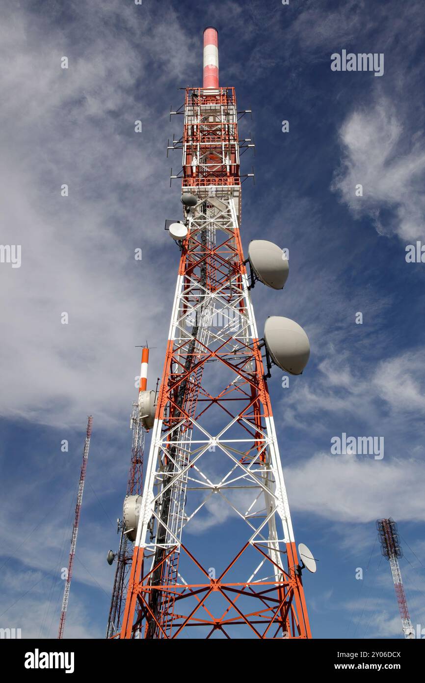 Red and white top of the mountain communication towers and satellite ...